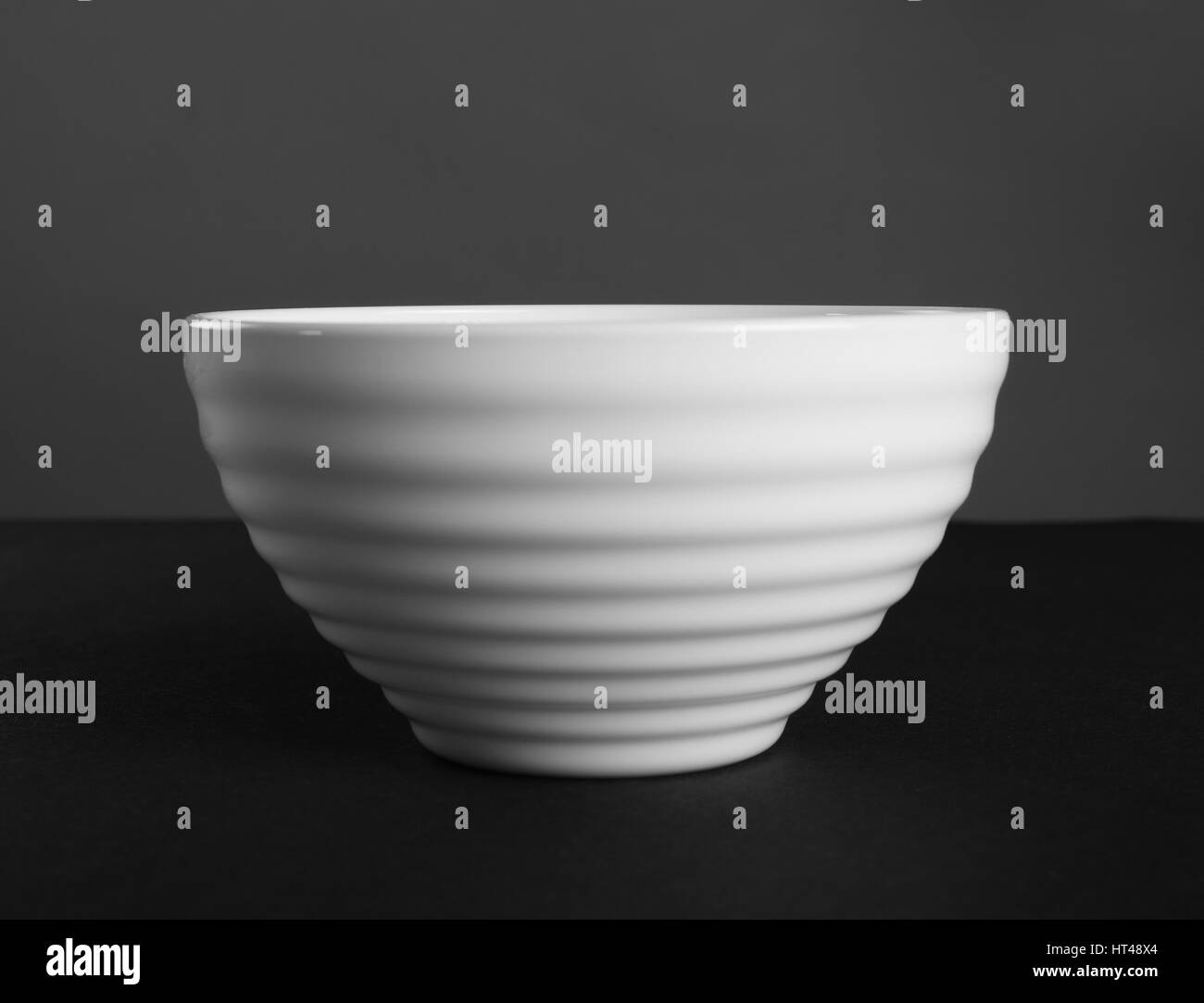 Deep round porcelain dish. White bowl front view Stock Photo - Alamy