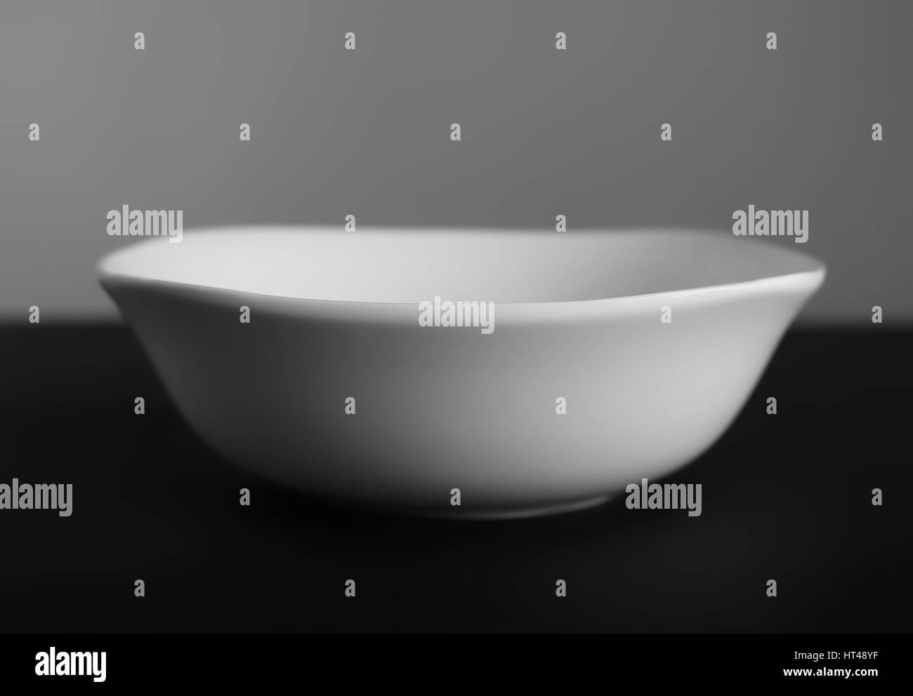 Deep round porcelain dish. White bowl front view Stock Photo - Alamy