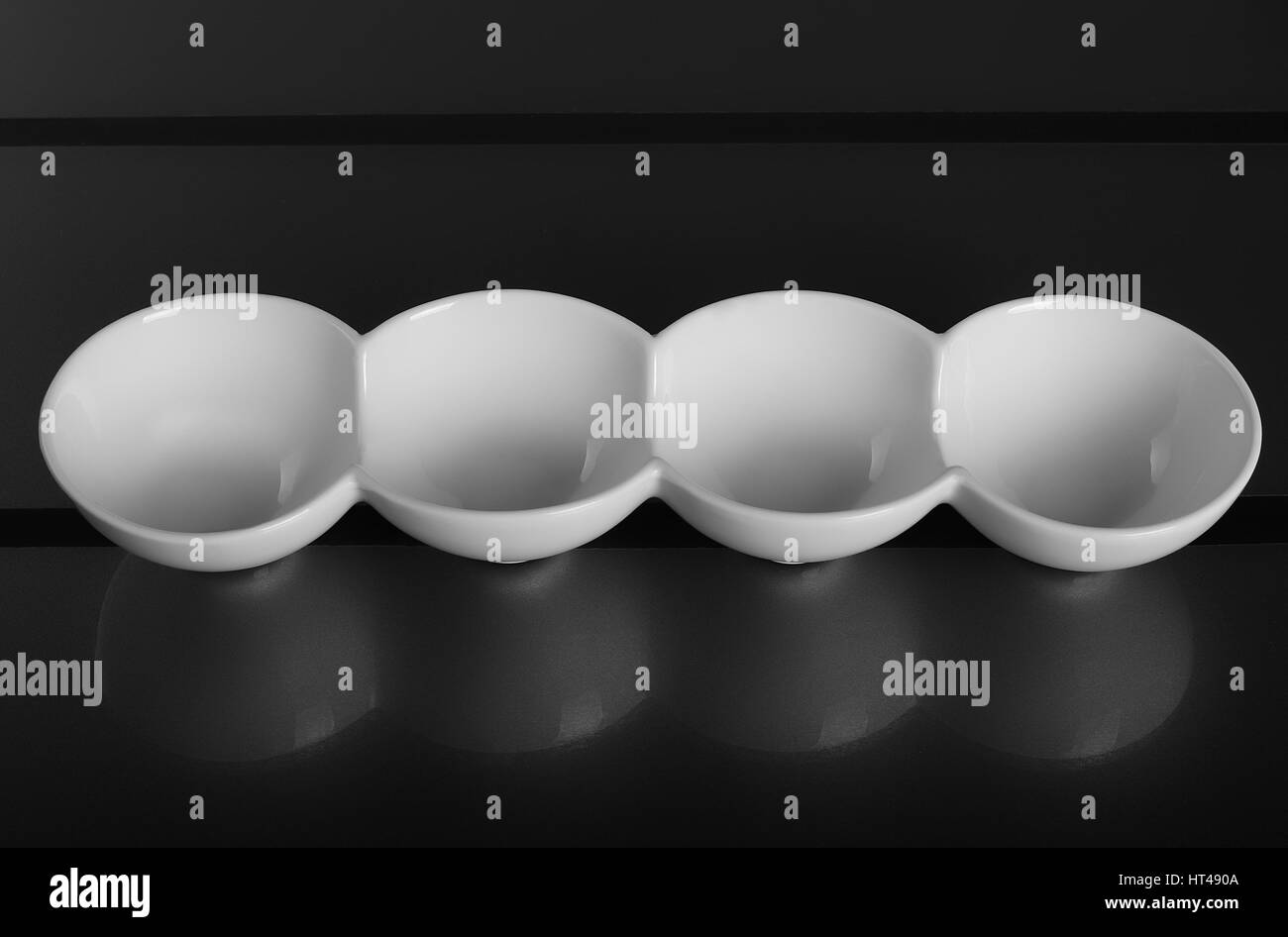 Round porcelain bowl with four compartments Stock Photo - Alamy