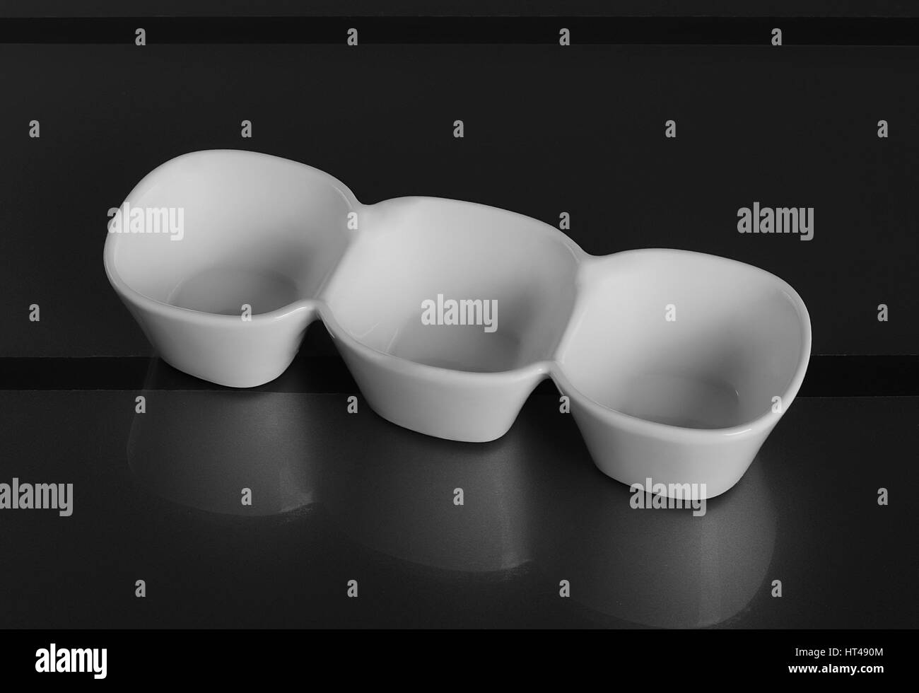 Deep porcelain bowl with three compartments Stock Photo - Alamy
