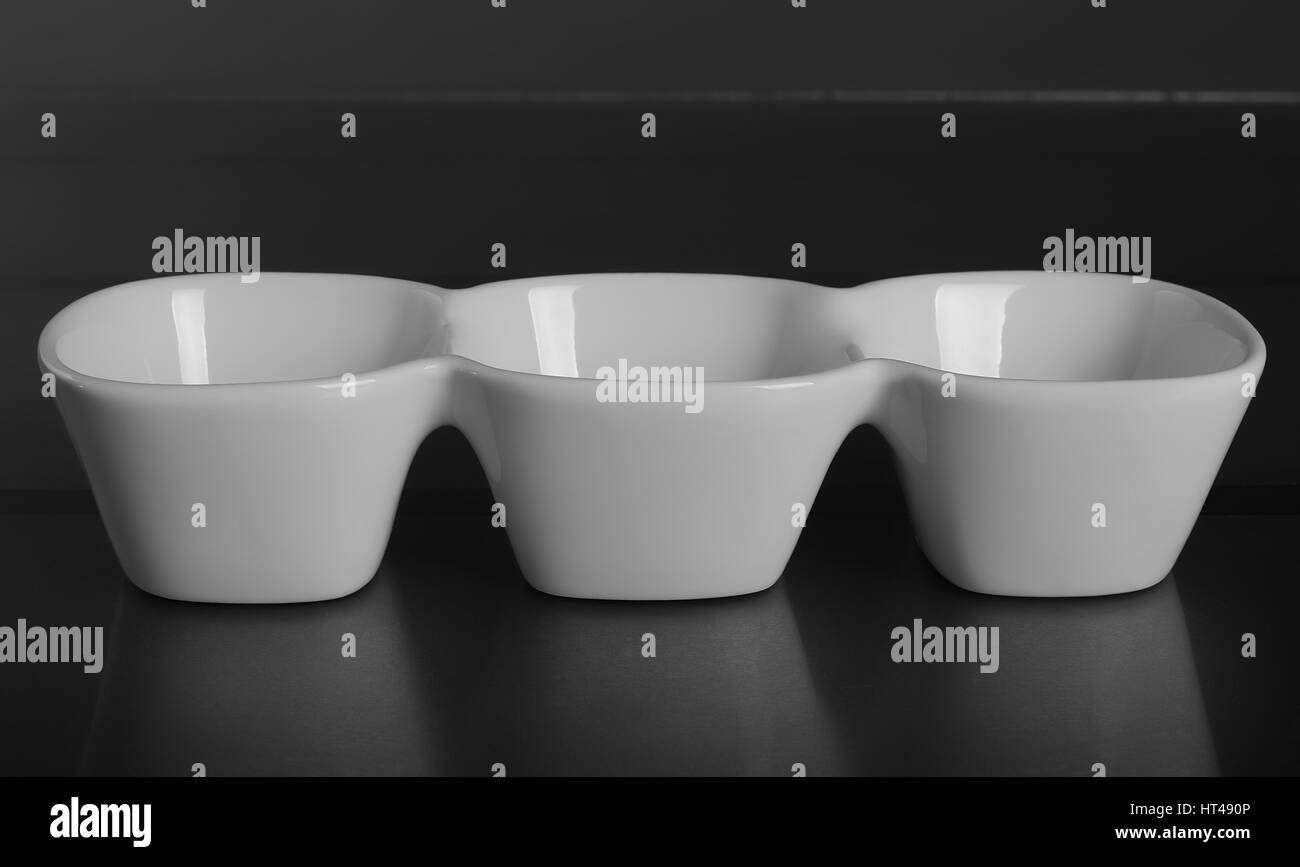 Deep porcelain bowl with three compartments Stock Photo - Alamy