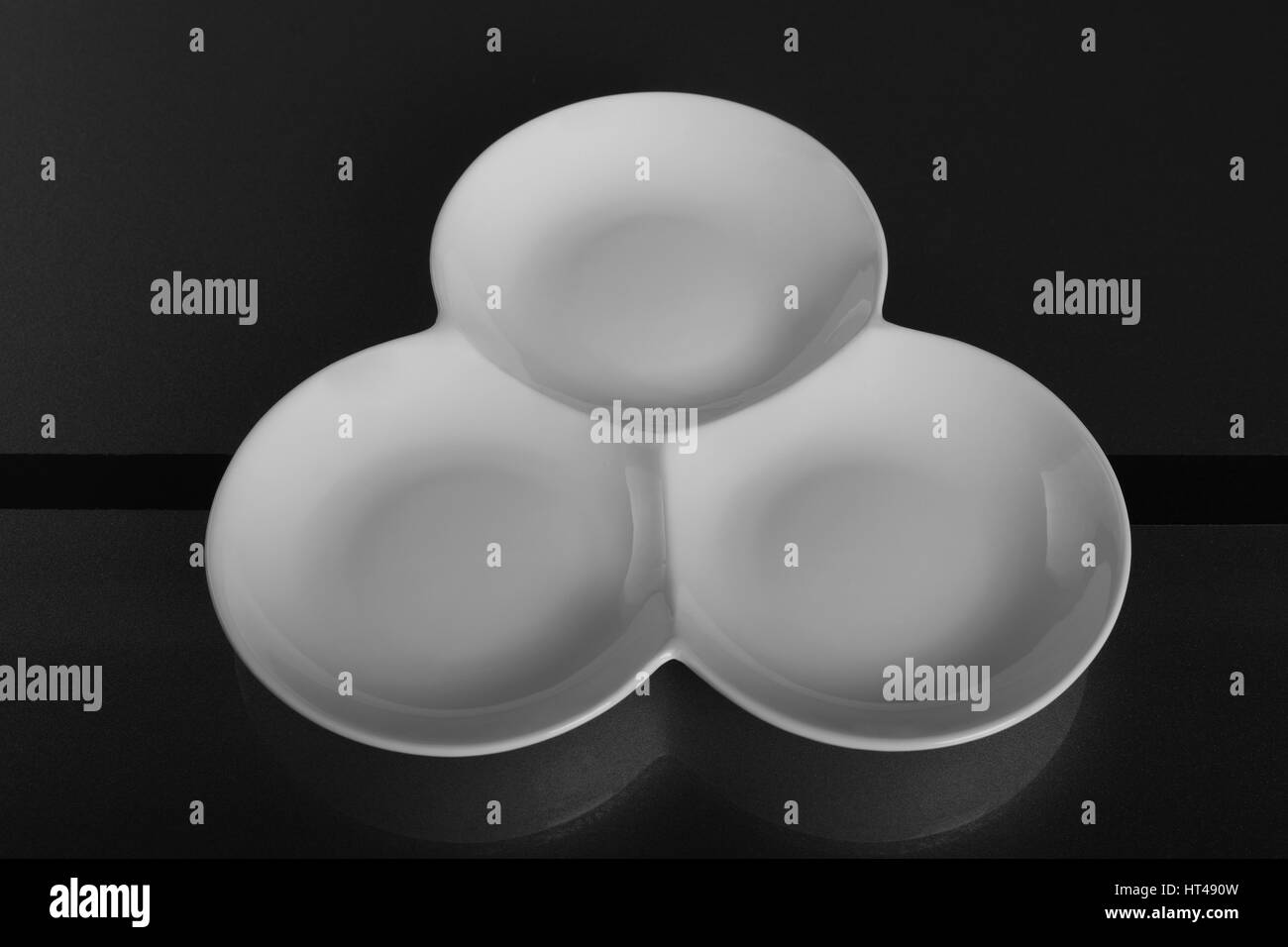 Round porcelain bowl with three compartments Stock Photo - Alamy