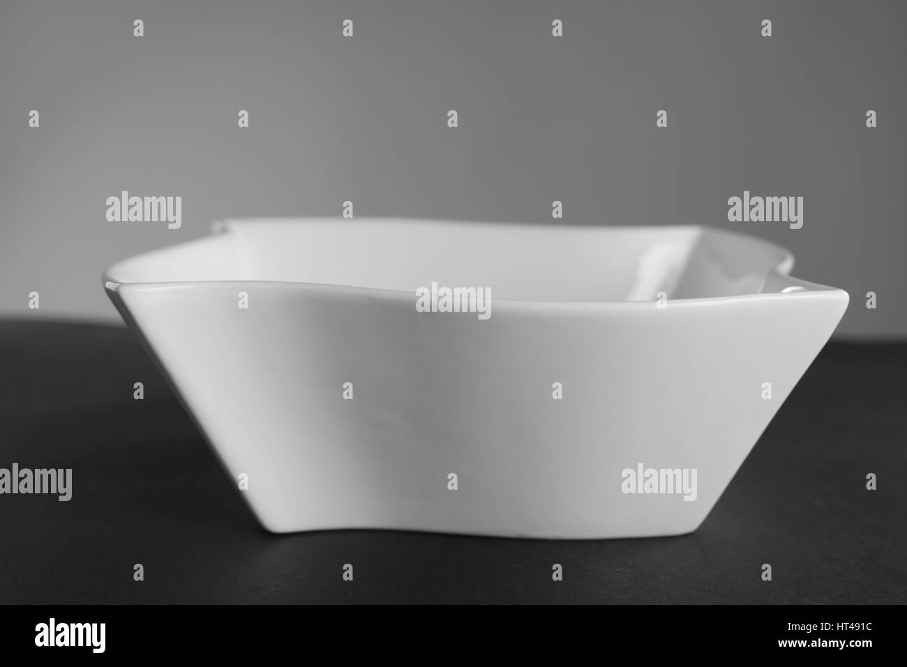 Deep round porcelain dish. White bowl front view Stock Photo - Alamy