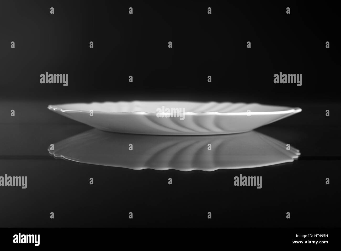 Porcelain round shallow dish with blurred background Stock Photo - Alamy