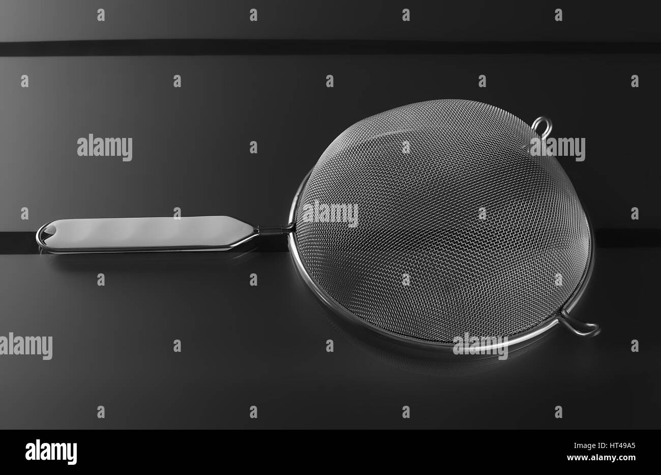 Metallic strainer with plastic handle, a modern kitchen utensil Stock ...