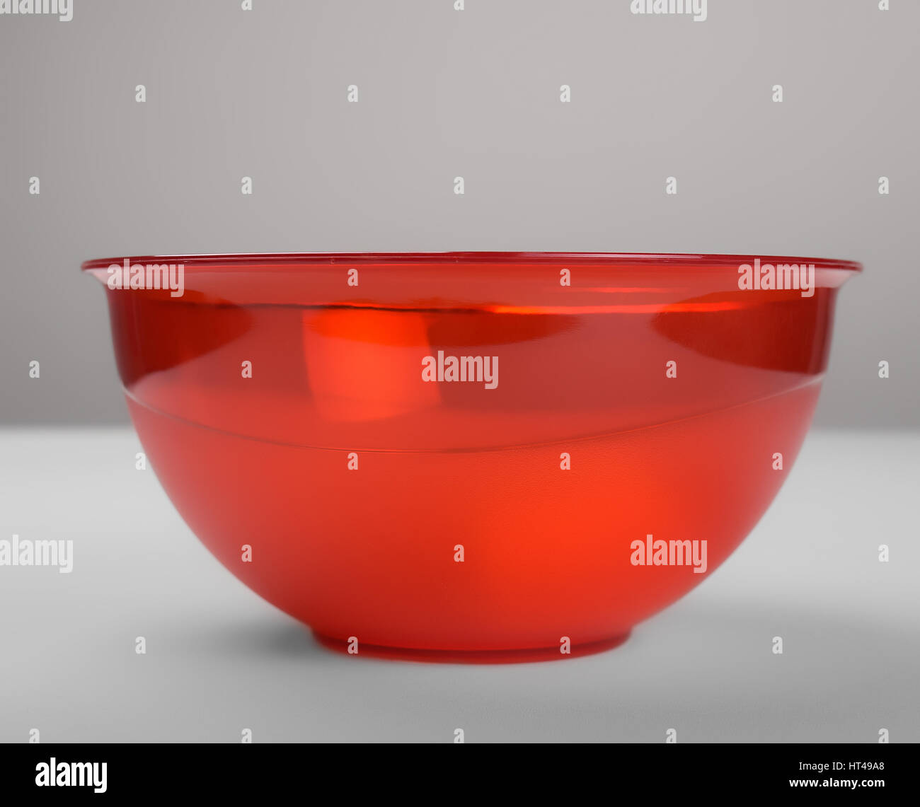 Red transparent plastic deep dish, front view Stock Photo - Alamy