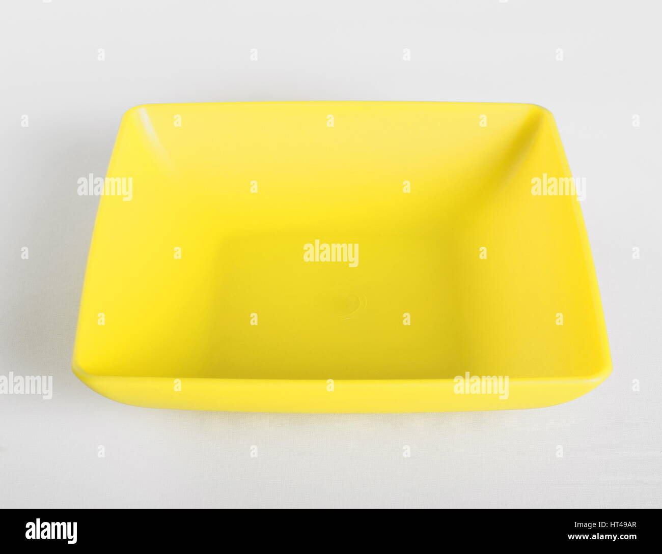 Yellow plastic shallow dish food Stock Photo - Alamy