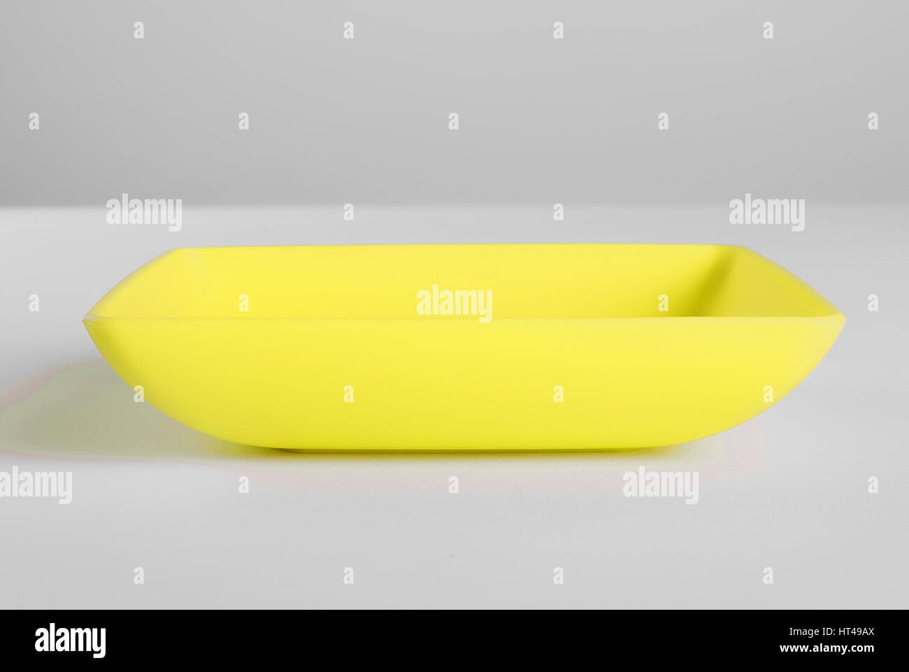 Yellow plastic shallow dish food Stock Photo - Alamy