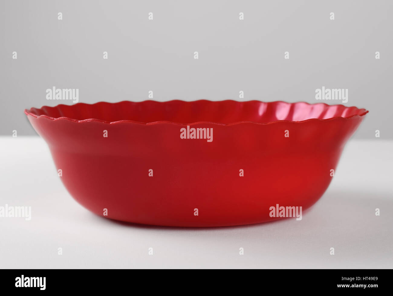 Red round plastic deep dish. front view Stock Photo - Alamy