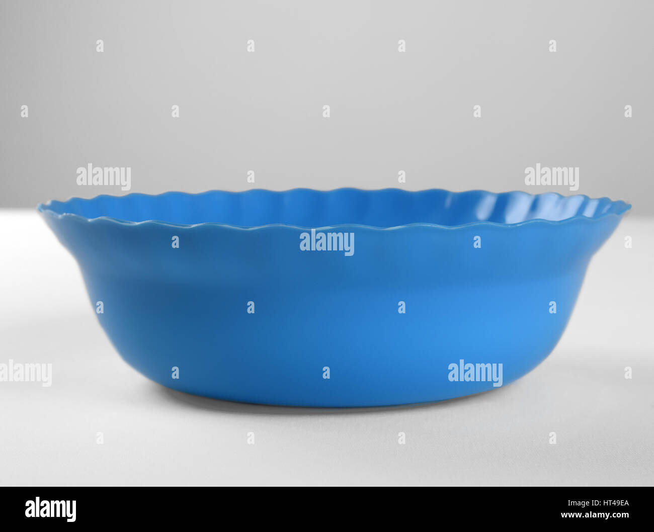 Blue round plastic deep dish, front view Stock Photo - Alamy