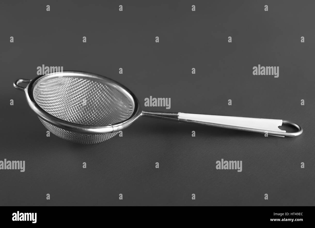 Metallic strainer with plastic handle, a modern kitchen utensil Stock ...