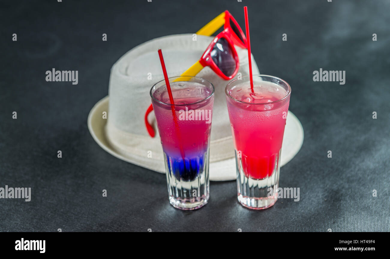 Two colored drinks, a combination of dark blue with purple, the second ...