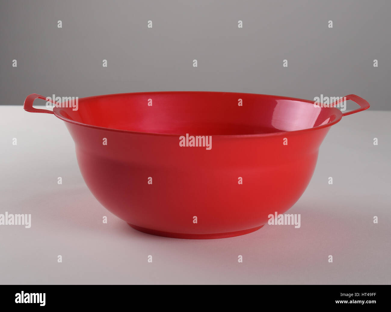 Red deep plastic bowl with handles Stock Photo - Alamy