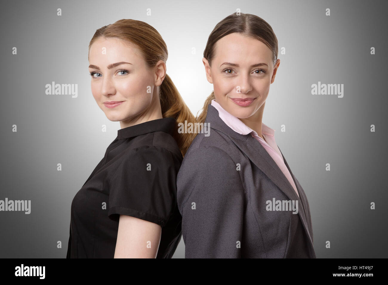 two business models standing with their backs together. Isolated on ...