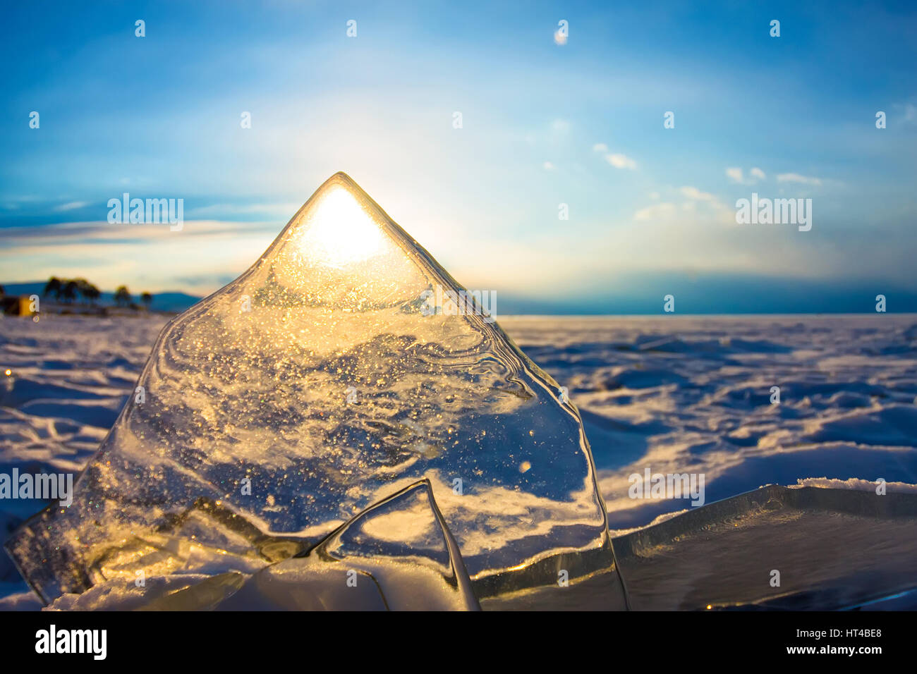 Sun at sunset shining through the transparent texture of the ice Stock ...