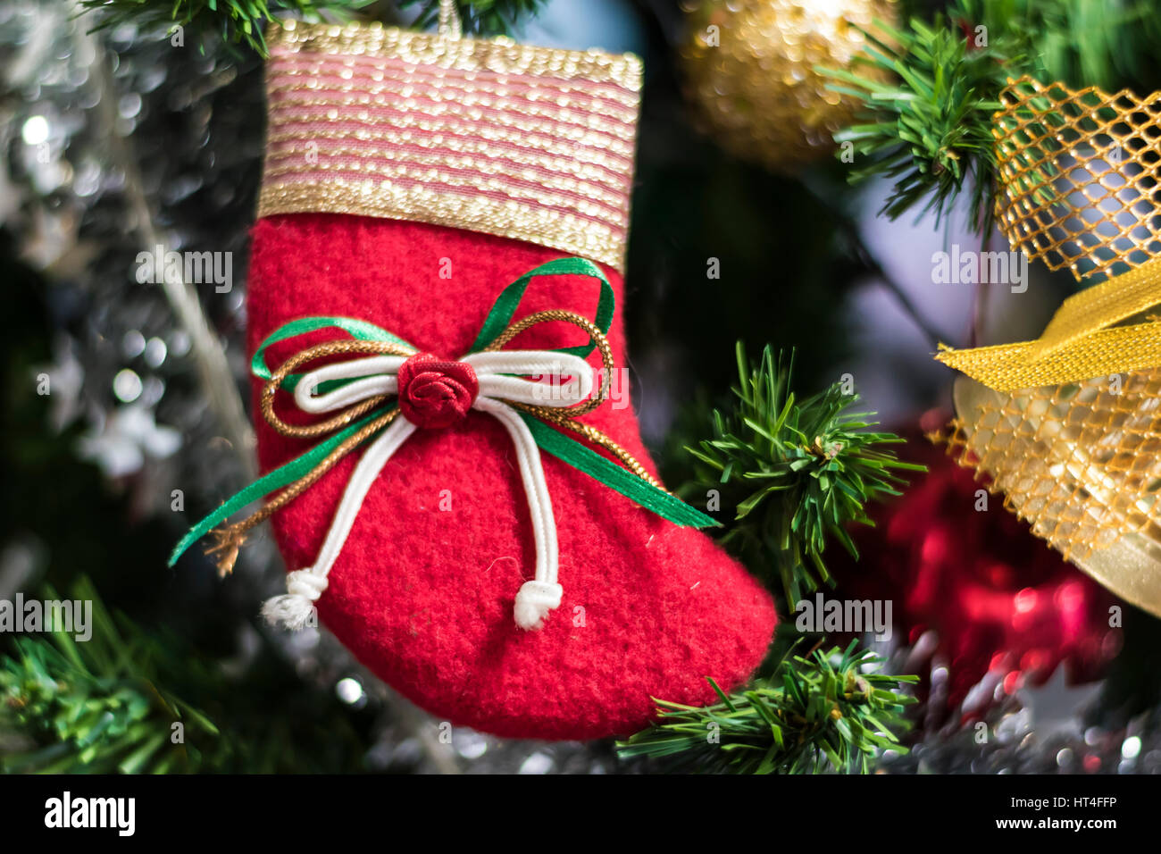 Beautifully decorated bright red Christmas socks hanging on a Chrismas ...