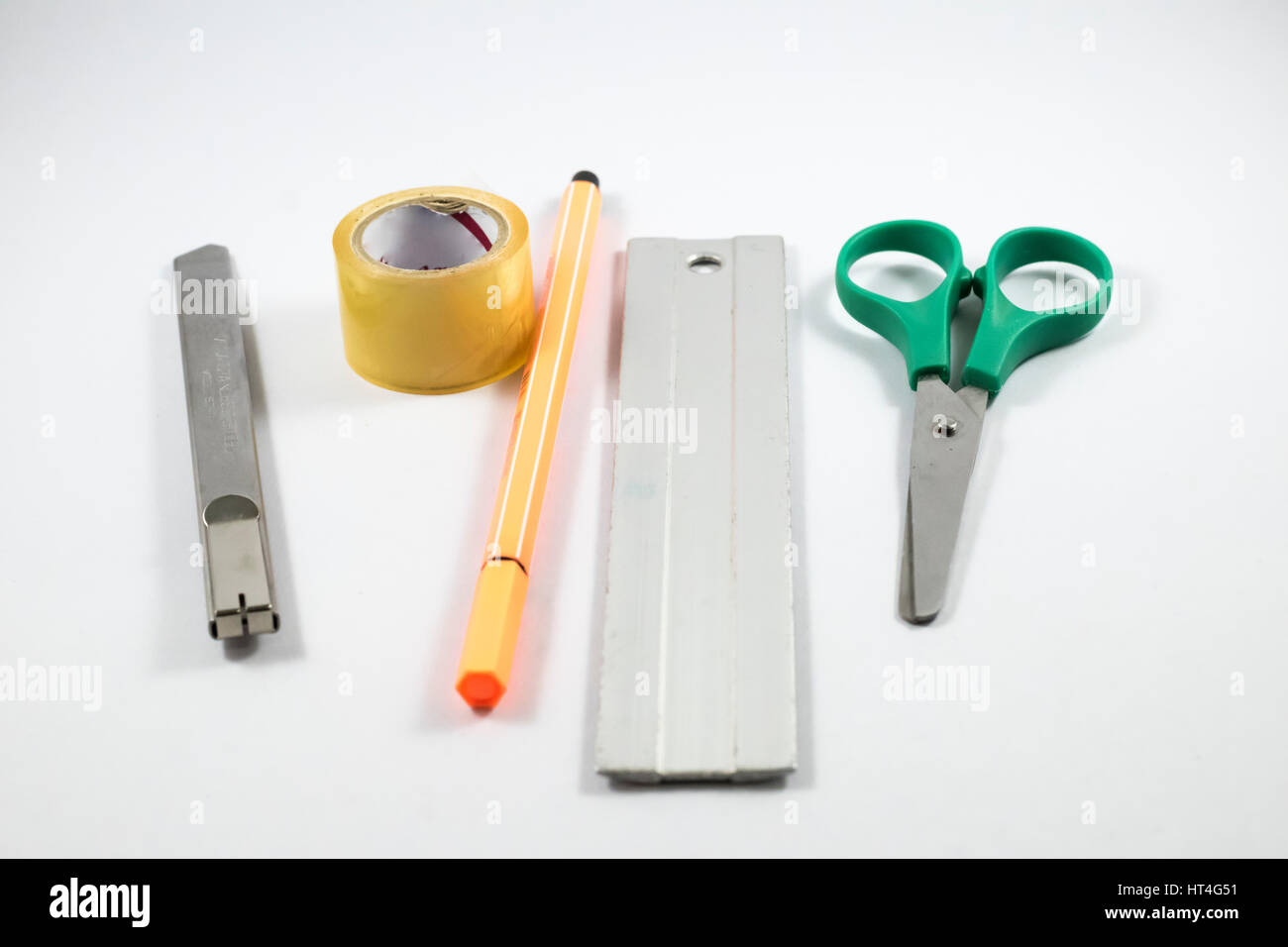 Scissor, ruler, cutter, tape and color pen on the white background ...