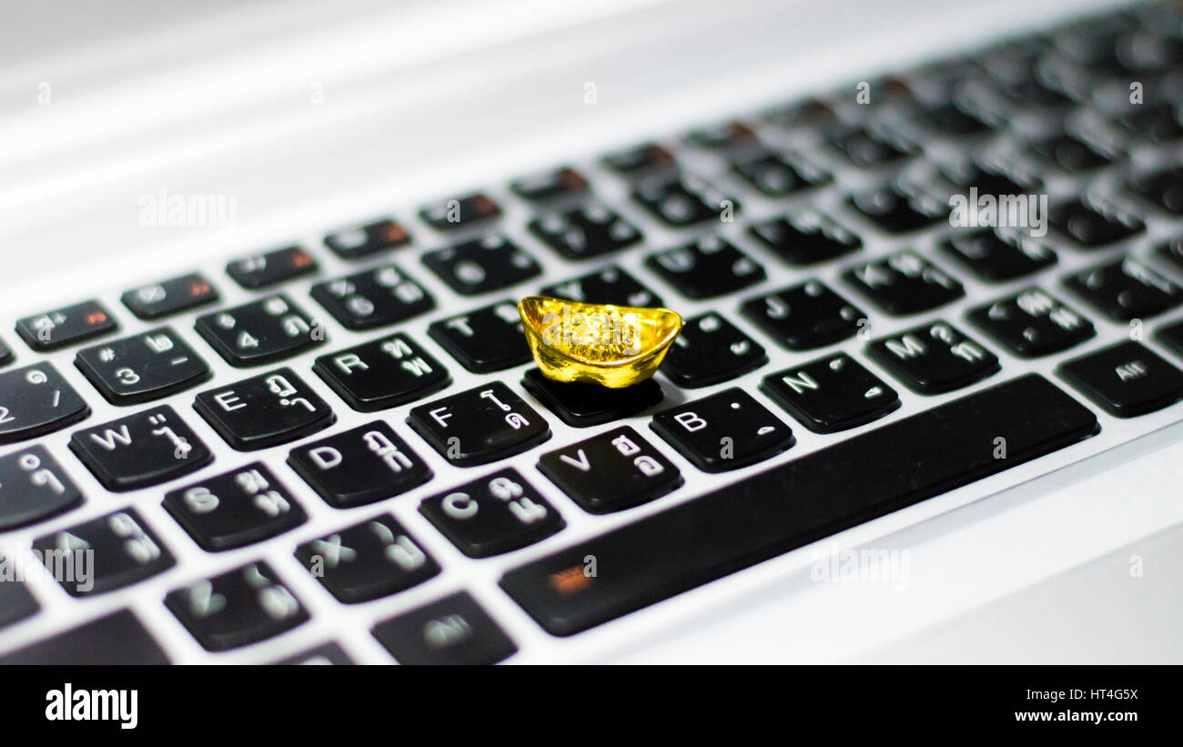 A gold bar on the computer keyboard Stock Photo - Alamy