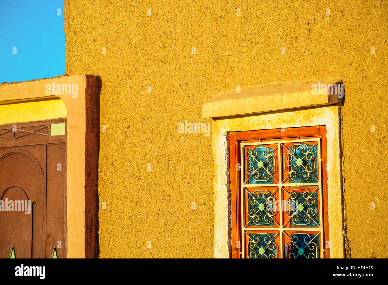 Rammed earth wall with traditional wrought iron window Stock Photo - Alamy