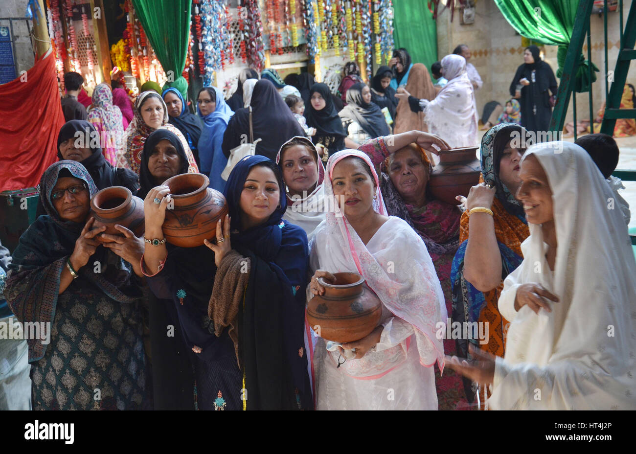 Lahore, Pakistan. 6th Mar, 2017. Pakistani women devotees bringing ...