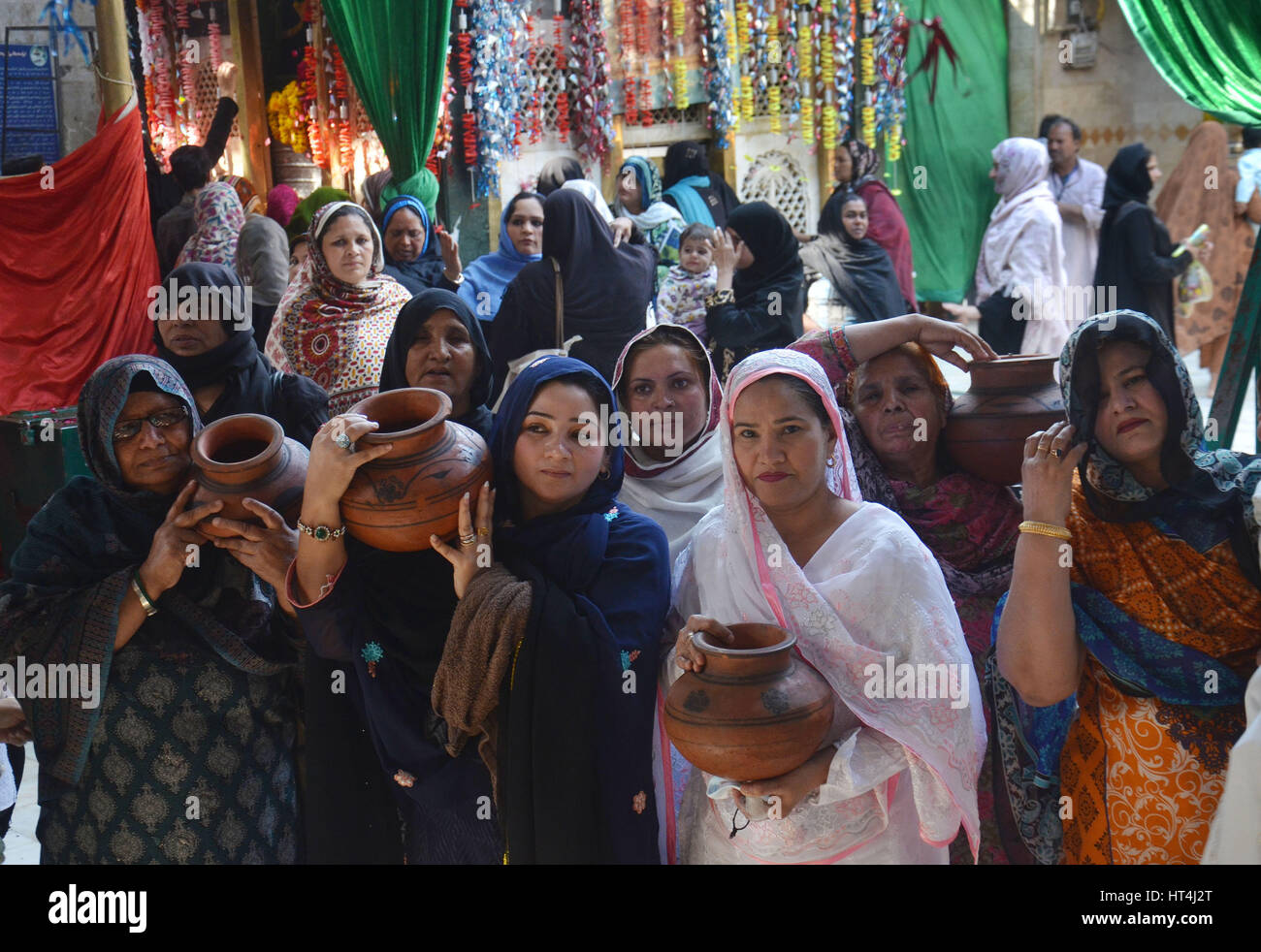 Lahore, Pakistan. 6th Mar, 2017. Pakistani women devotees bringing ...