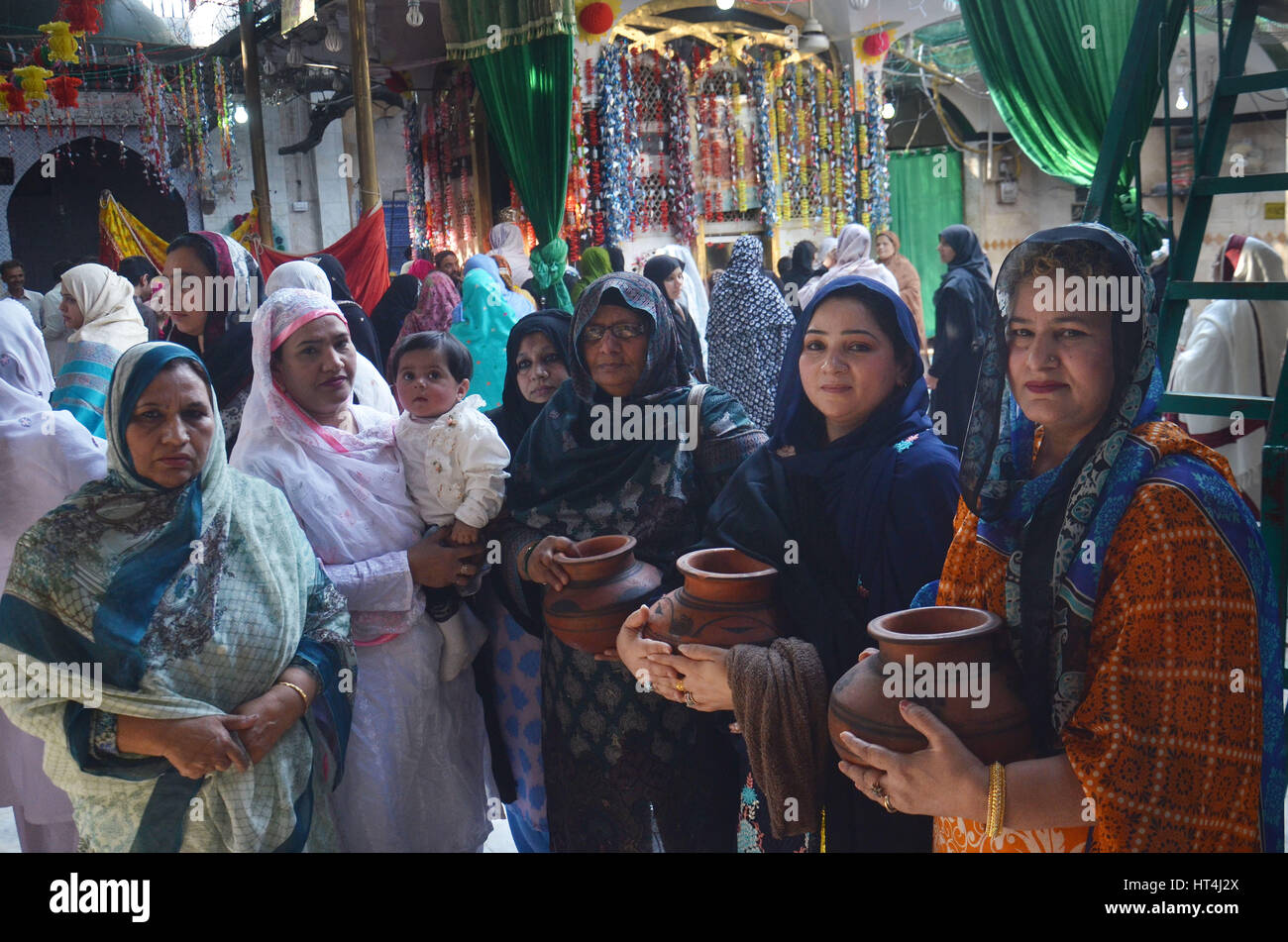 Lahore, Pakistan. 6th Mar, 2017. Pakistani women devotees bringing ...