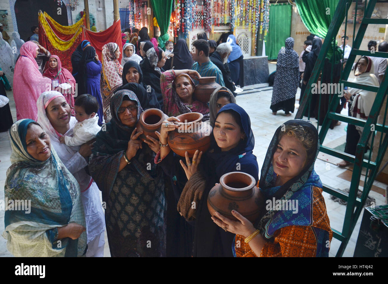 Lahore, Pakistan. 6th Mar, 2017. Pakistani women devotees bringing ...