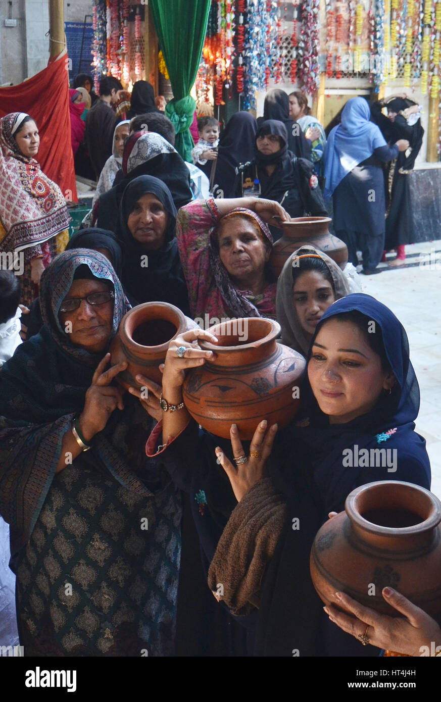 Lahore, Pakistan. 6th Mar, 2017. Pakistani women devotees bringing ...