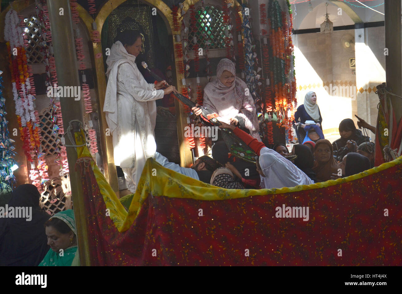 Lahore, Pakistan. 6th Mar, 2017. Pakistani women devotees bringing ...