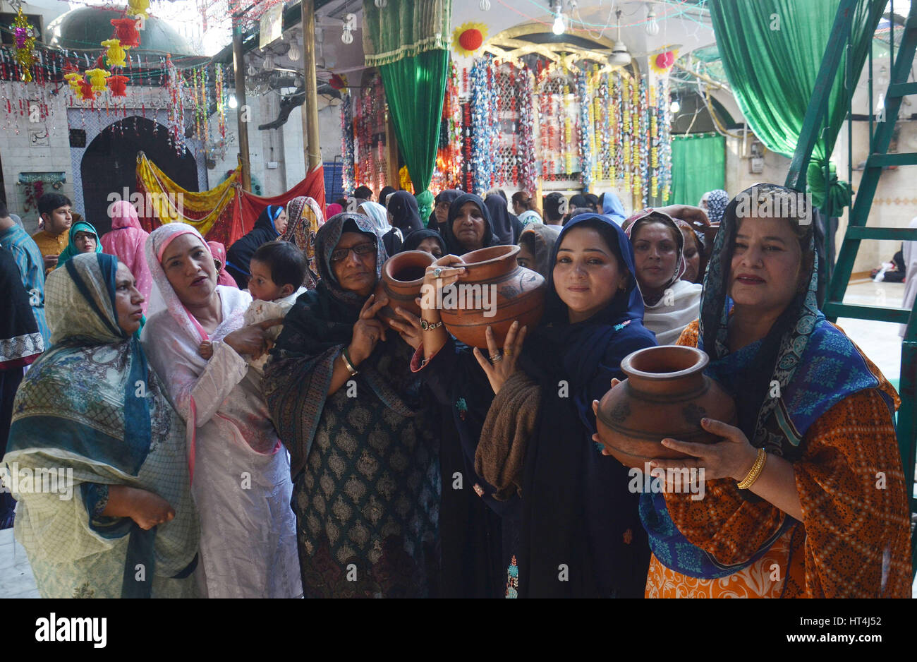 Lahore, Pakistan. 6th Mar, 2017. Pakistani women devotees bringing ...