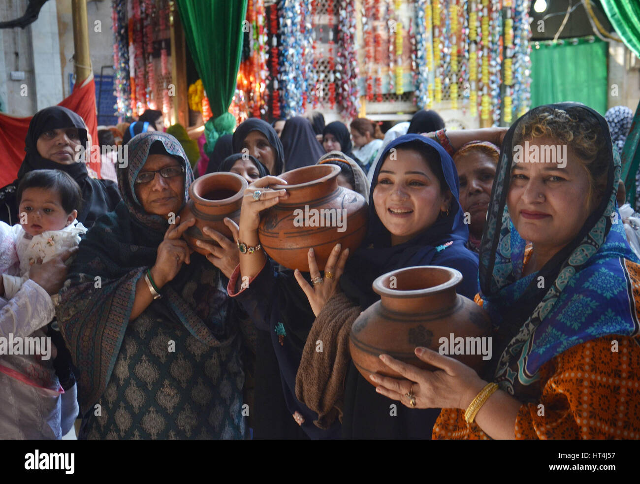Lahore, Pakistan. 6th Mar, 2017. Pakistani women devotees bringing ...