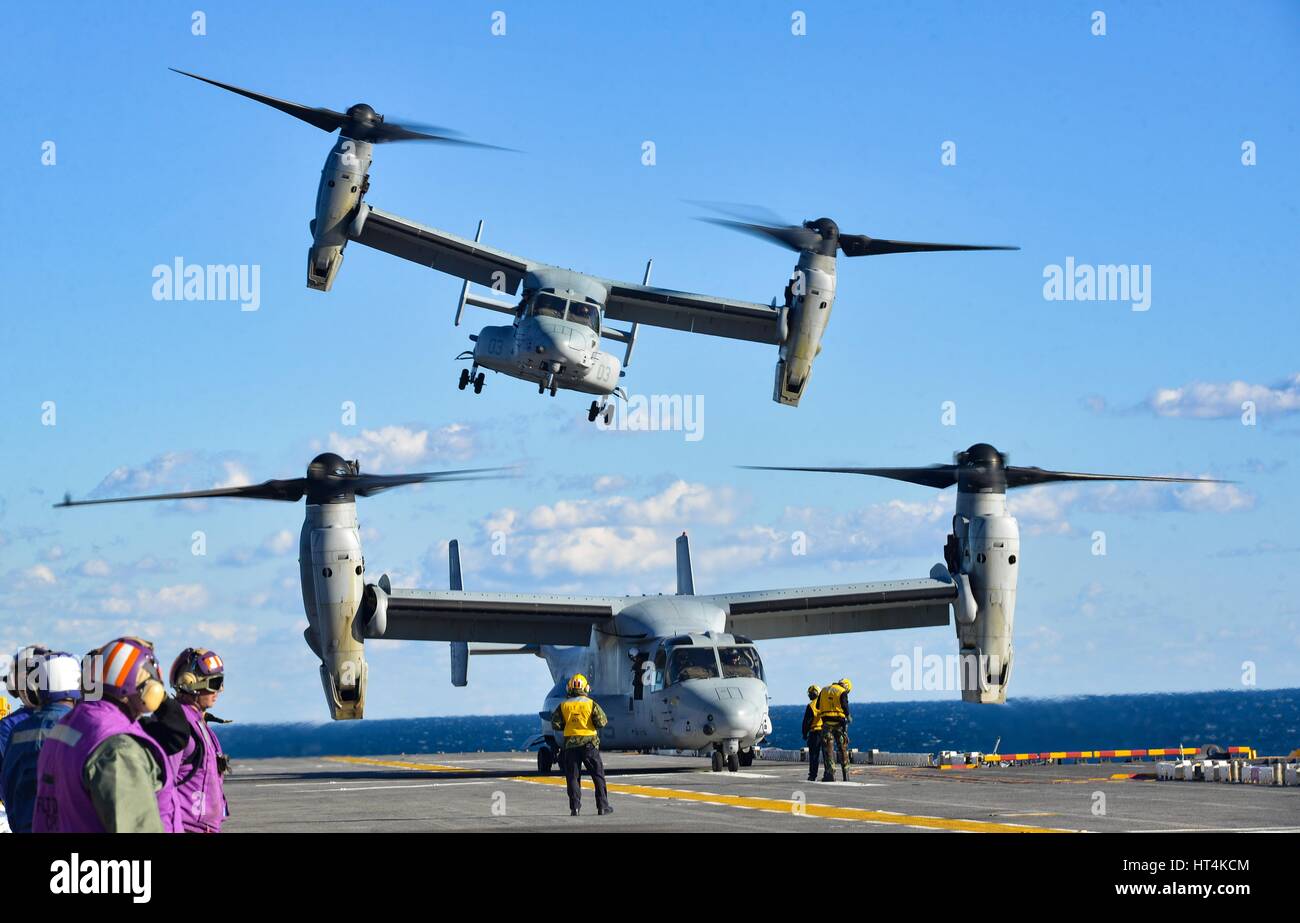 A U.S. Marine Corps MV-22 Osprey aircraft launches from the flight deck ...