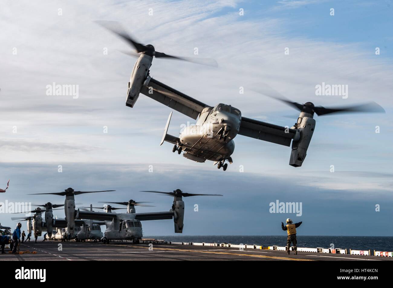 A U.S. Marine Corps MV-22 Osprey aircraft launches from the flight deck ...