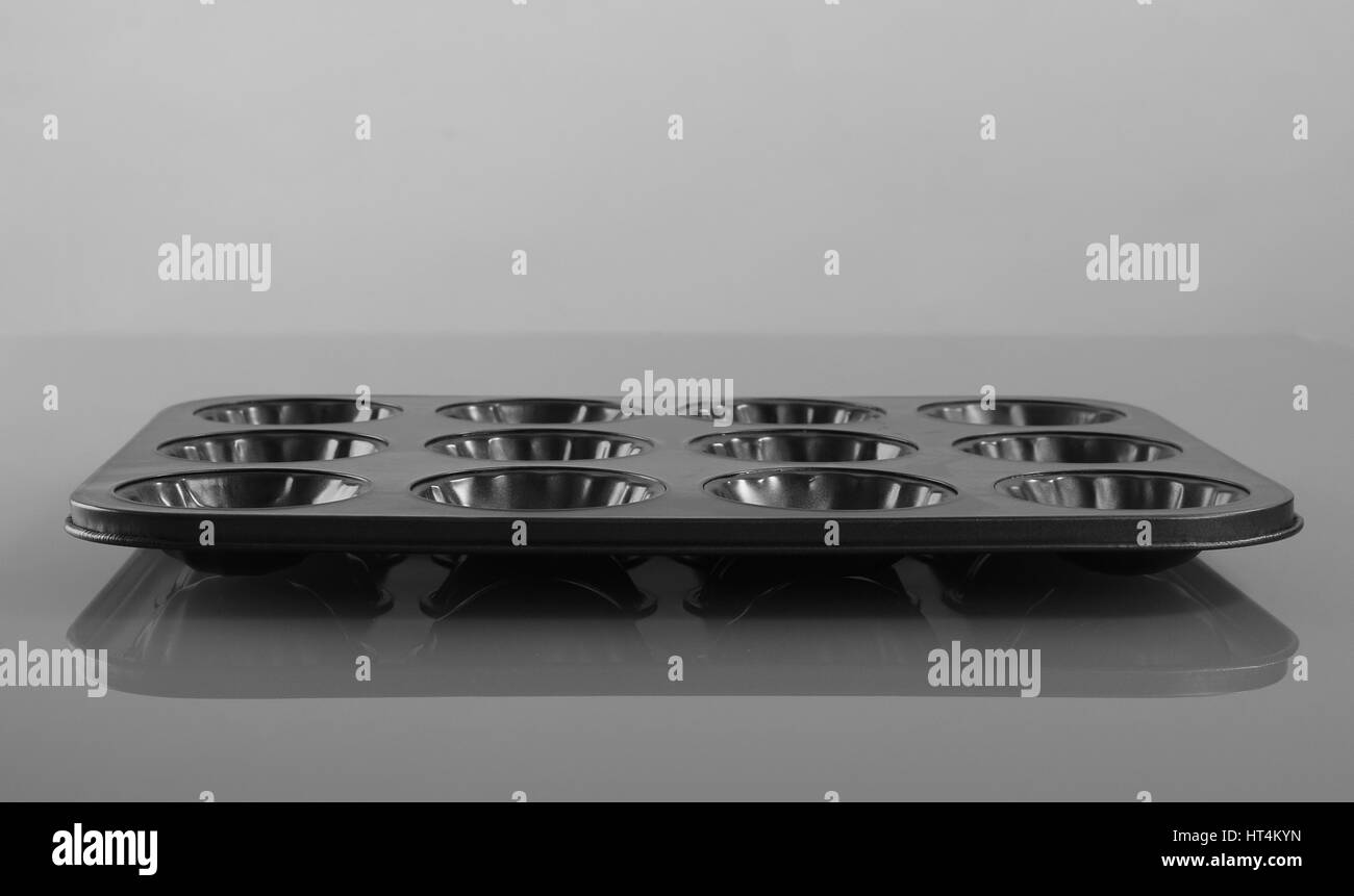 Cooking, baking and home concept. Close up of empty muffins molds ...