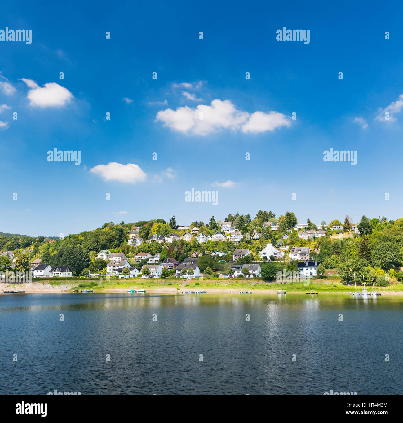 Square view of Rurberg lake front at Lake Rursee with perfect blue sky ...
