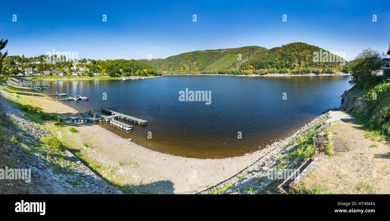 Panoramic view of Rurberg village with houses overlooking Lake Rursee ...