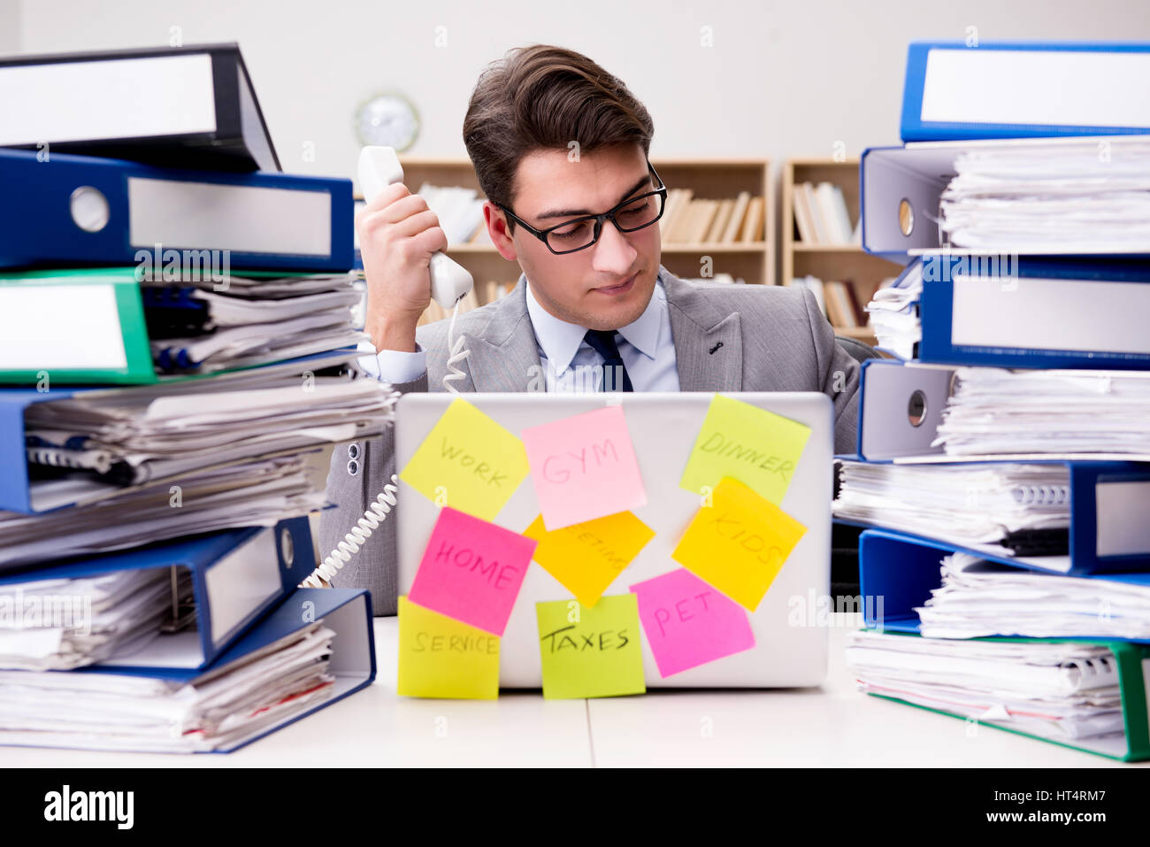 Businessman struggling with multiple priorities Stock Photo - Alamy