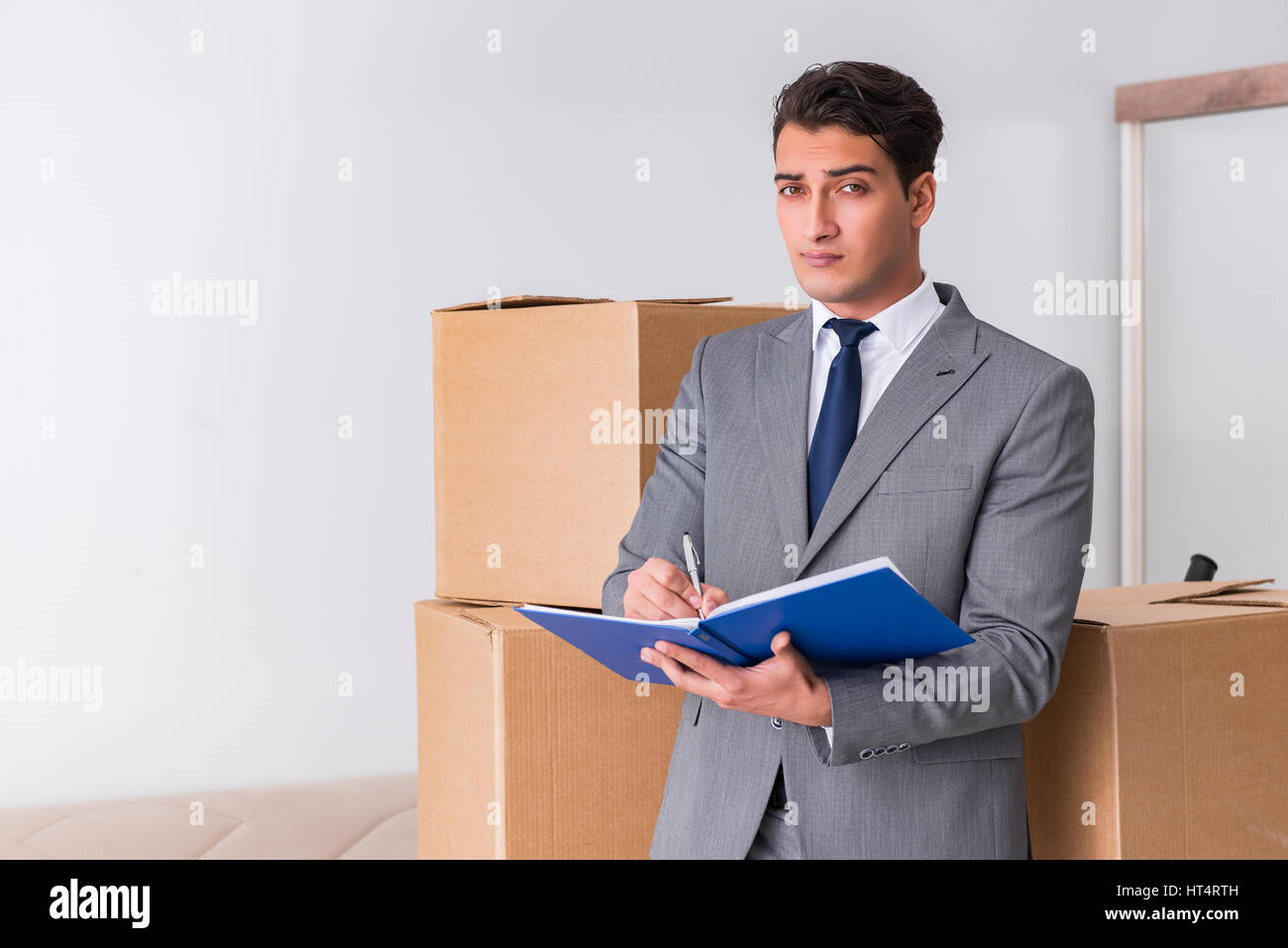 Man signing for the delivery of boxes Stock Photo - Alamy