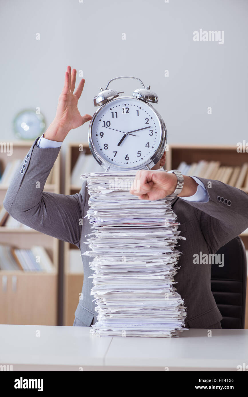 Businessman busy with paperwork in office Stock Photo - Alamy