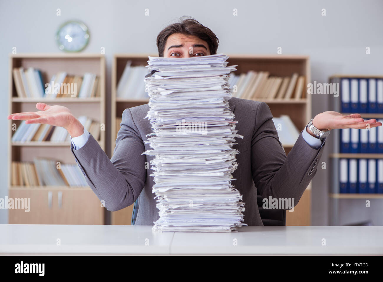 Businessman busy with paperwork in office Stock Photo - Alamy