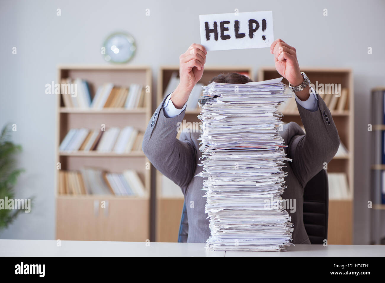 Businessman busy with paperwork in office Stock Photo - Alamy