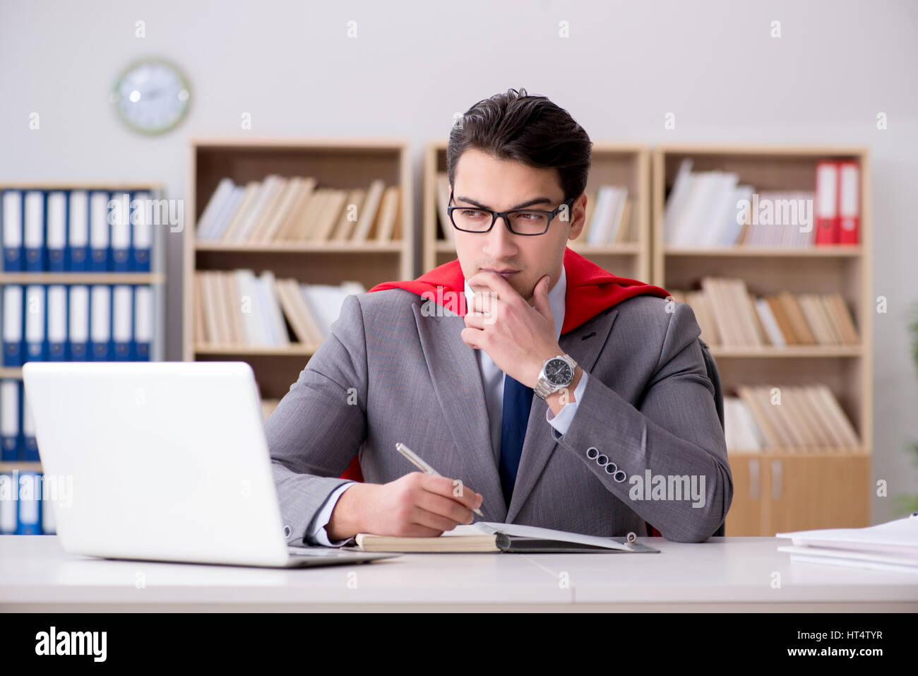 Superhero businessman working in the office Stock Photo - Alamy