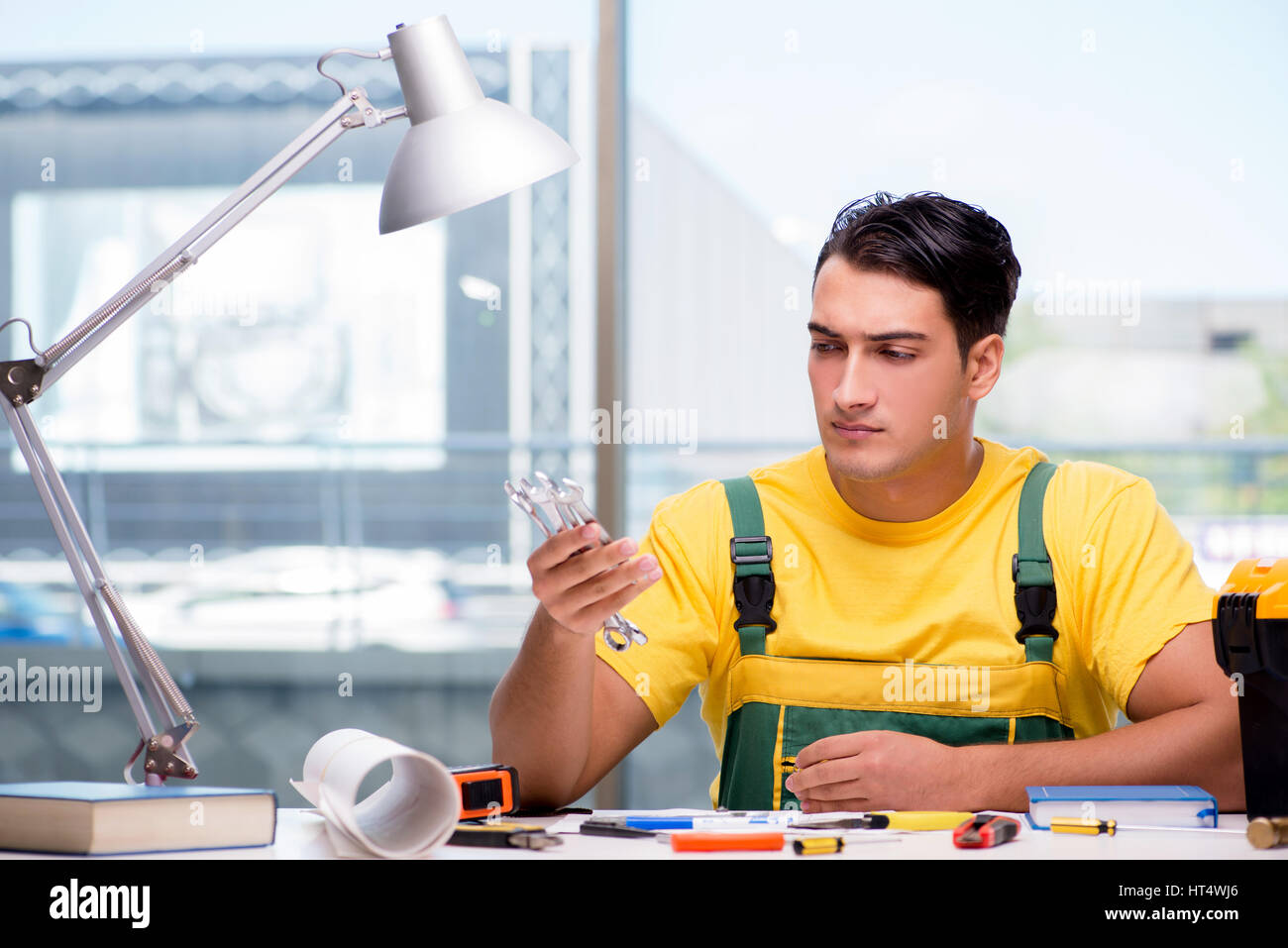 Construction worker sitting at the desk Stock Photo - Alamy