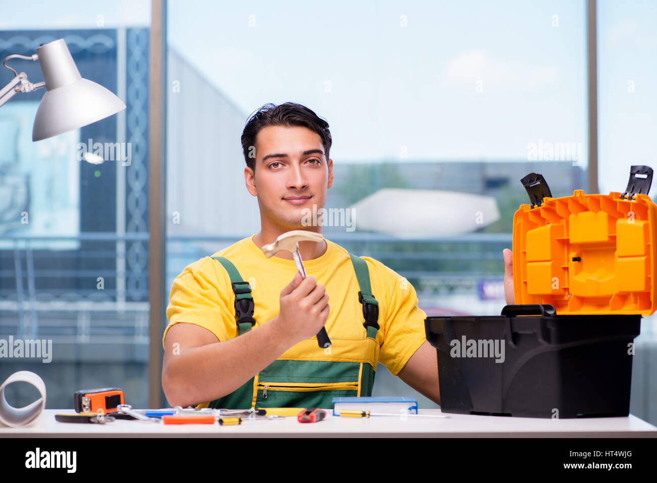 Construction worker sitting at the desk Stock Photo - Alamy