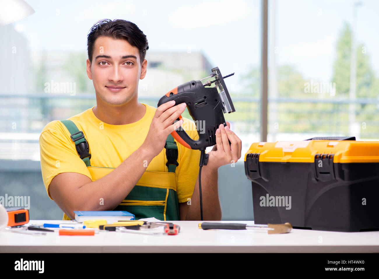Construction worker sitting at the desk Stock Photo - Alamy