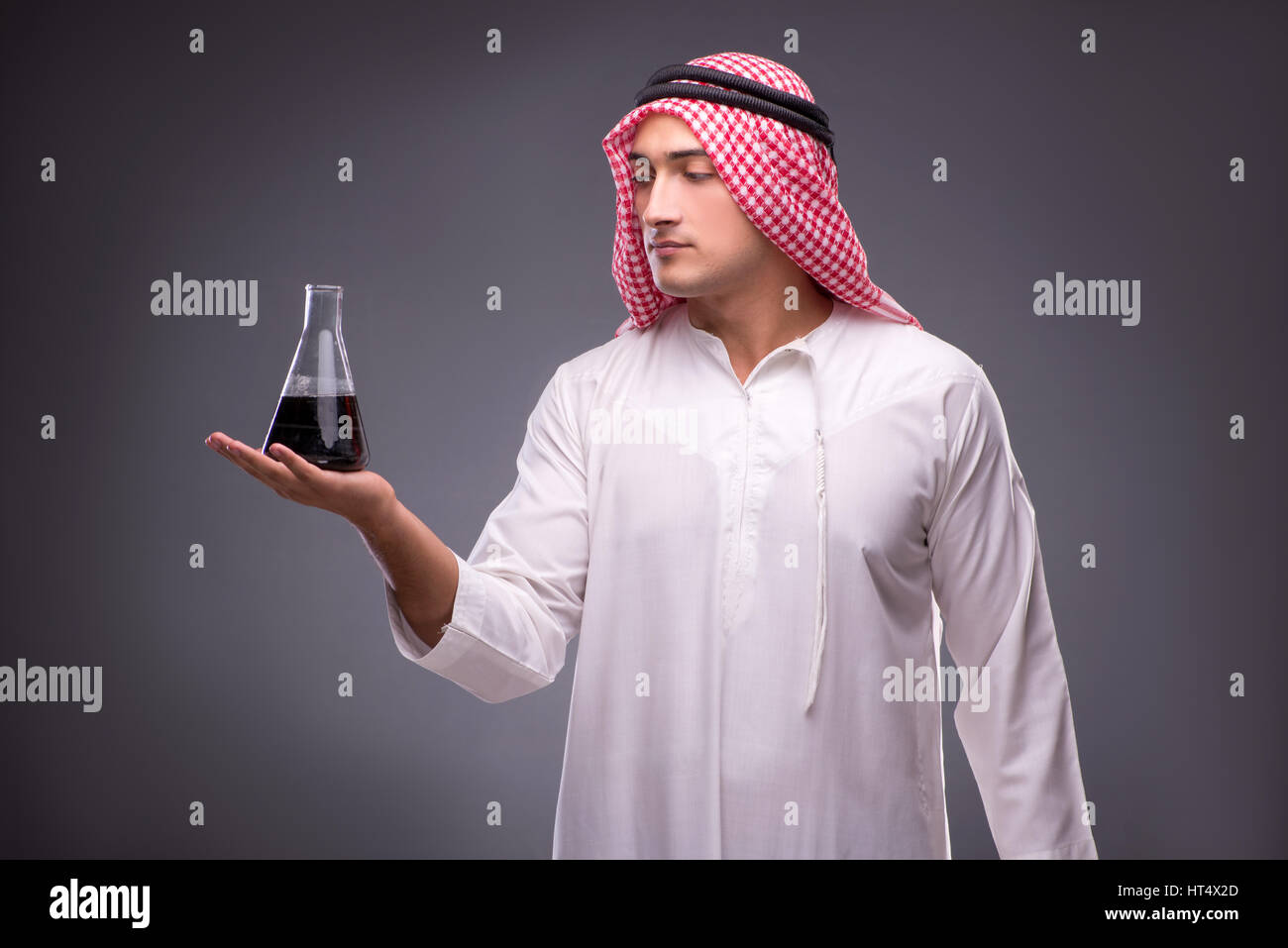 Arab with oil on gray background Stock Photo - Alamy