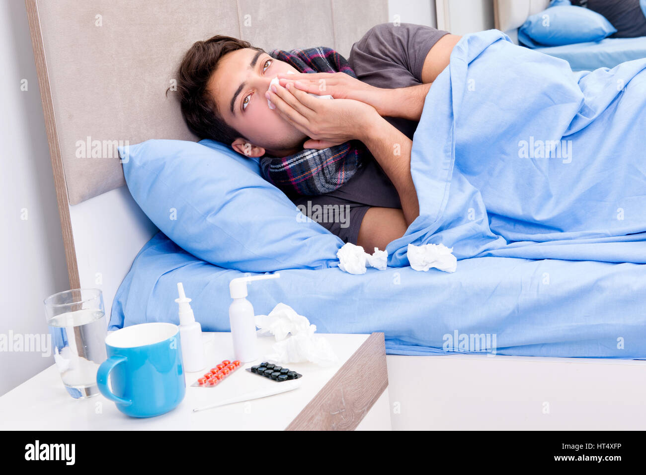 Sick ill man in the bed taking medicines and drugs Stock Photo - Alamy