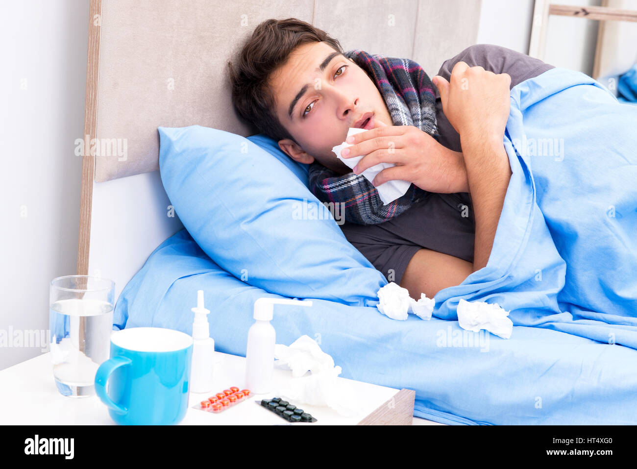 Sick man with flu lying in the bed Stock Photo - Alamy