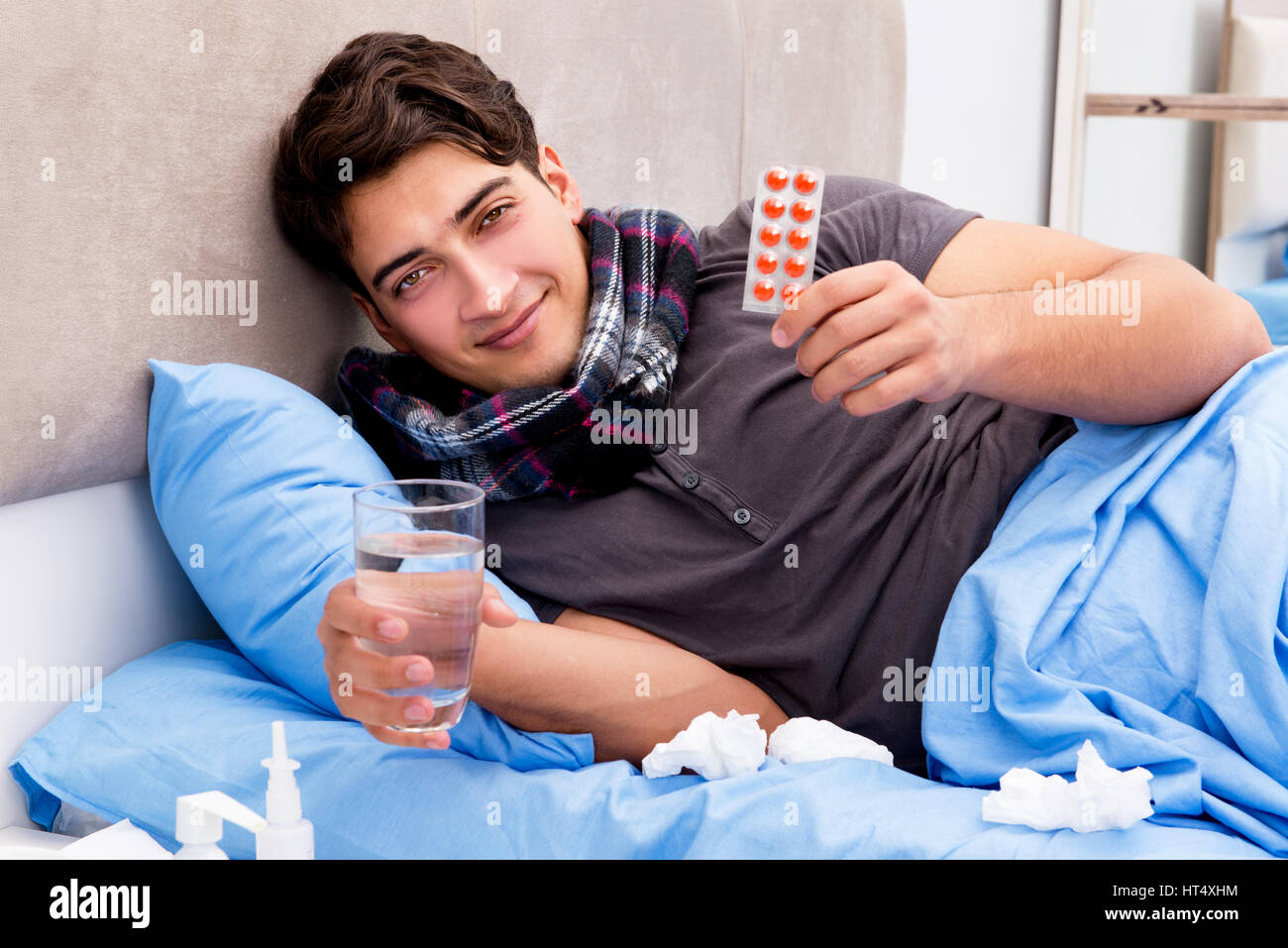 Sick ill man in the bed taking medicines and drugs Stock Photo - Alamy