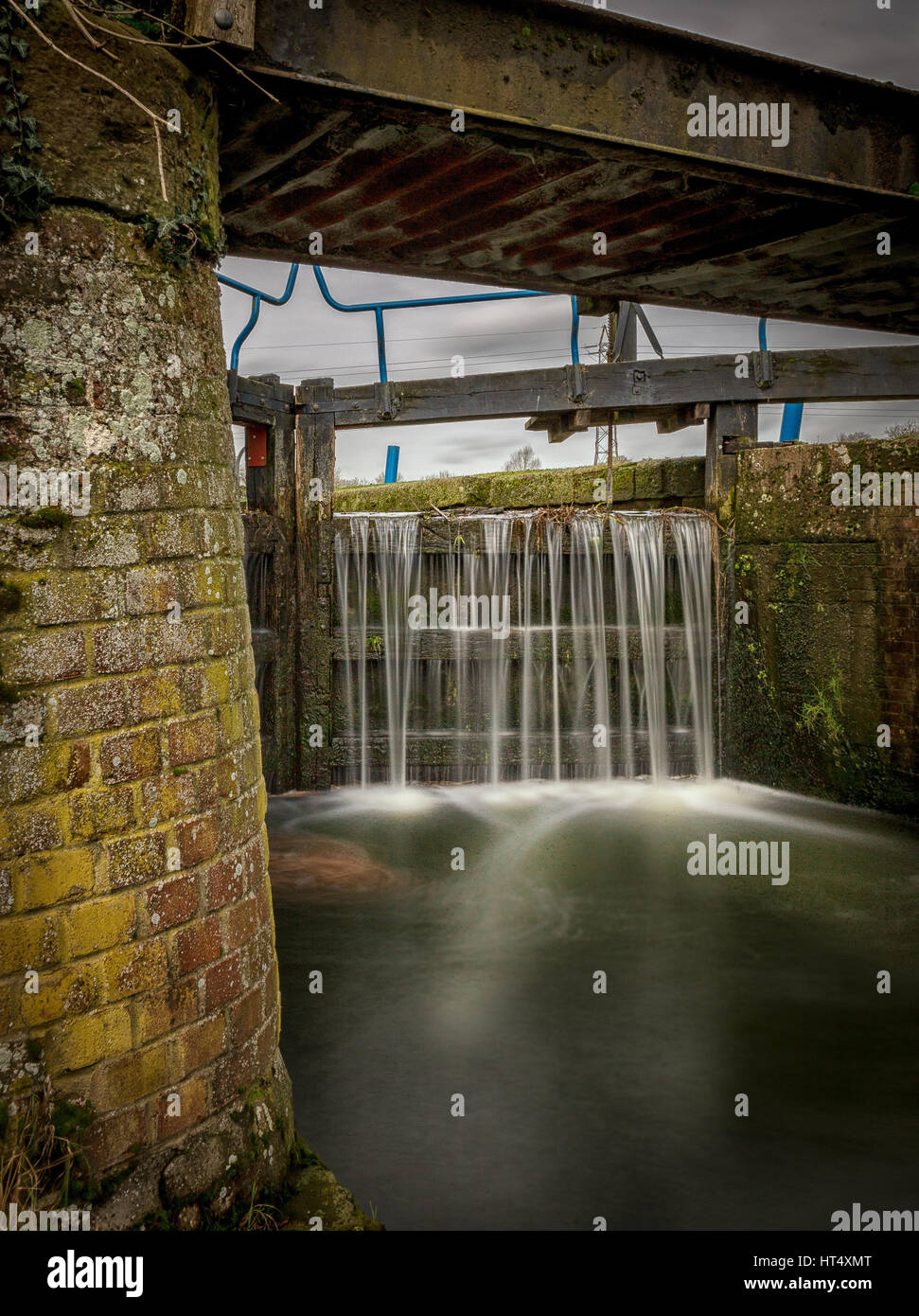Water flowing through the lock gate system and waterfall at Beeleigh ...